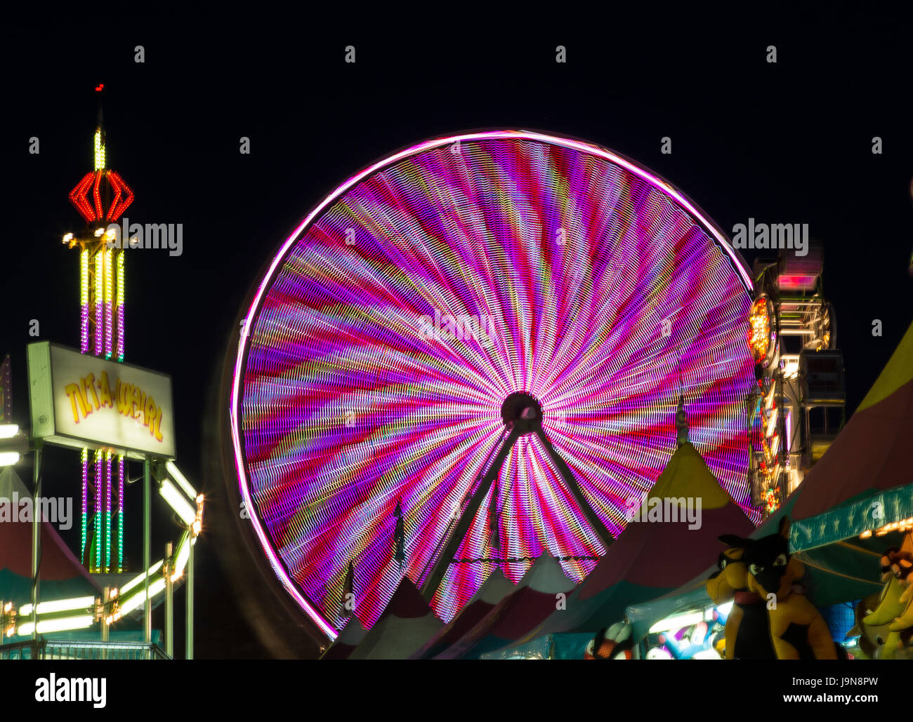 Spinning rides are colorful at the county fair Stock Photo - Alamy