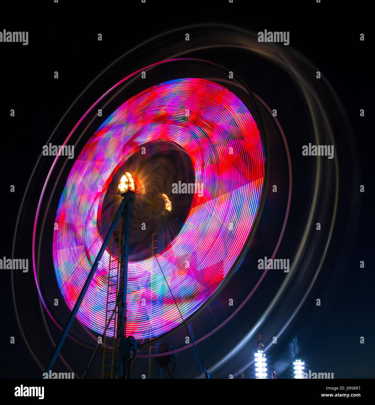 Spinning rides are colorful at the county fair Stock Photo - Alamy