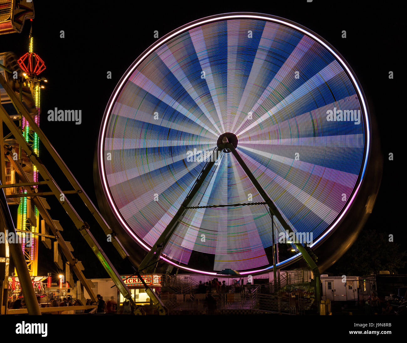 Spinning rides are colorful at the county fair Stock Photo - Alamy