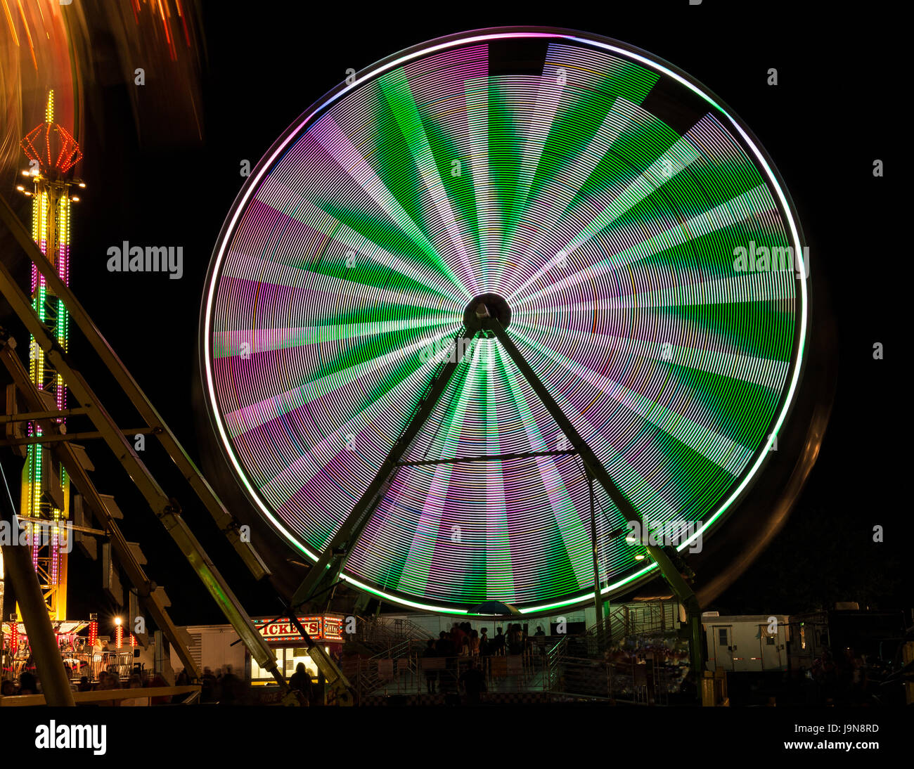 Spinning rides are colorful at the county fair Stock Photo - Alamy