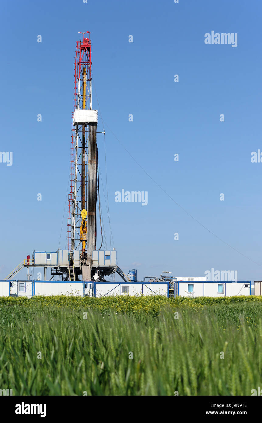 land oil drilling rig on green wheat field Stock Photo - Alamy
