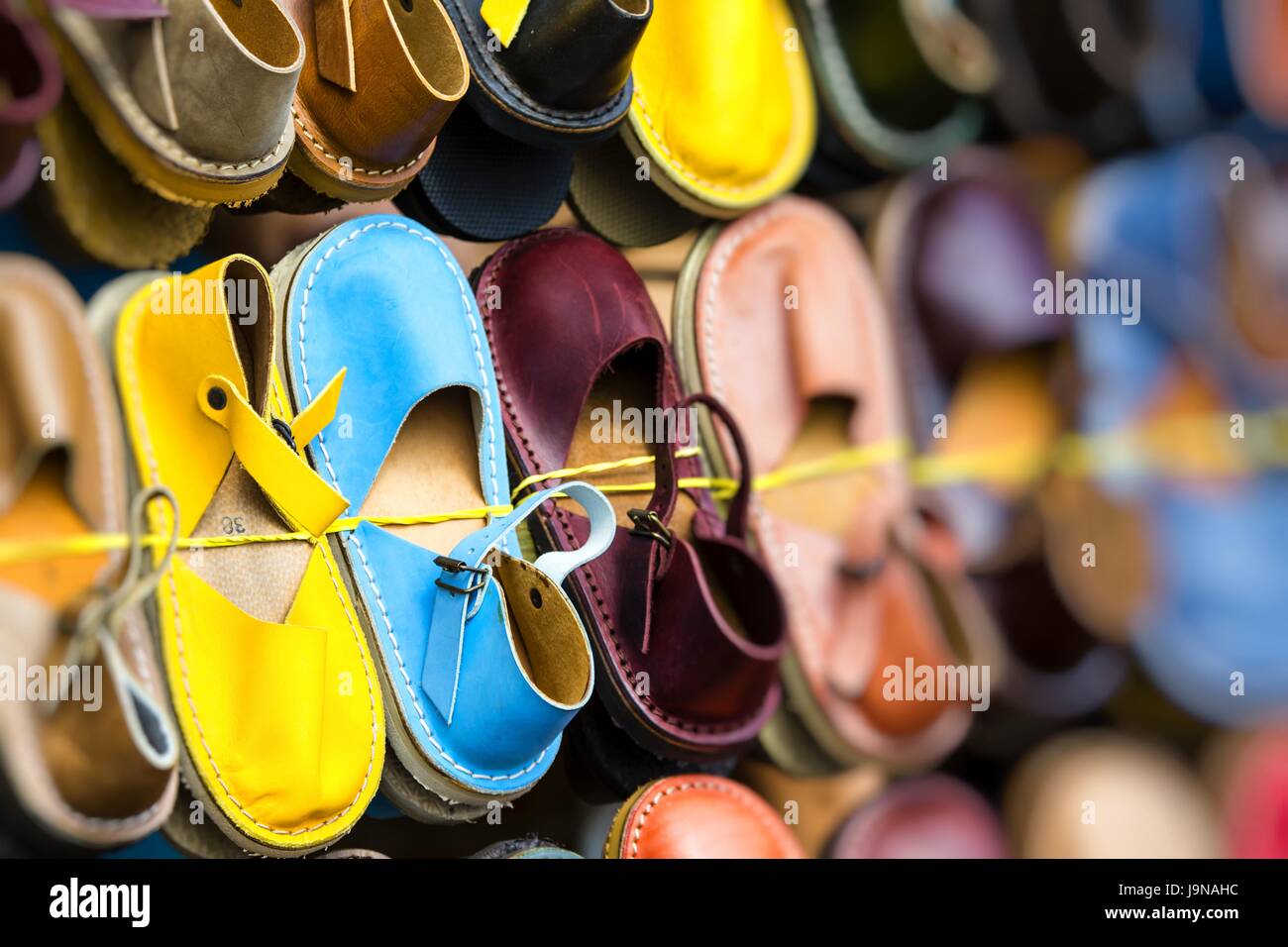 Leather shoes in different colors at a flea market Stock Photo - Alamy