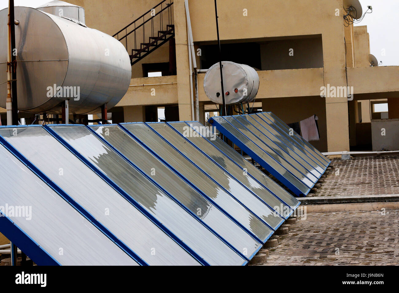 Solar panel cells for household use on flat roof top Stock Photo - Alamy