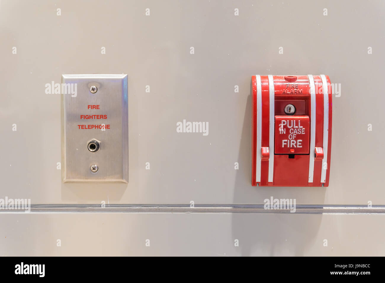 Push button switch fire alarm box on cement wall for warning and ...