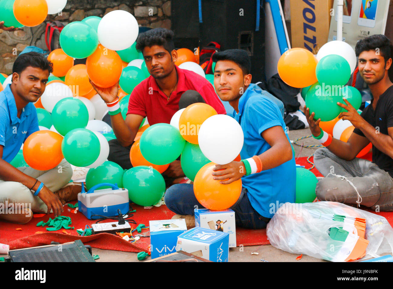 Young men preparing balloons of tricolor, Indian national flag for ...