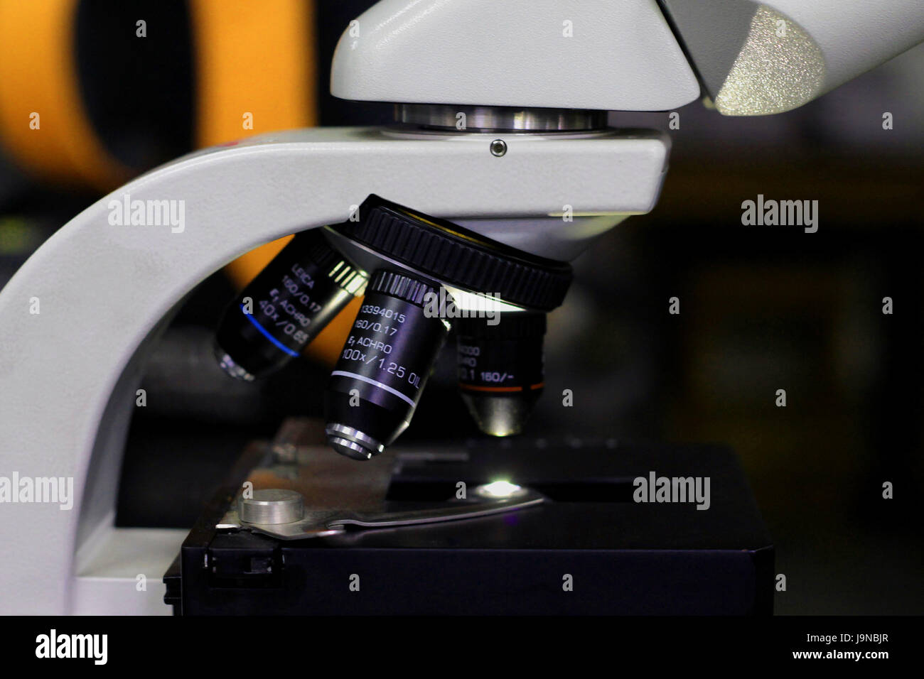 side view of microscope in a research lab showing the objective lenses ...