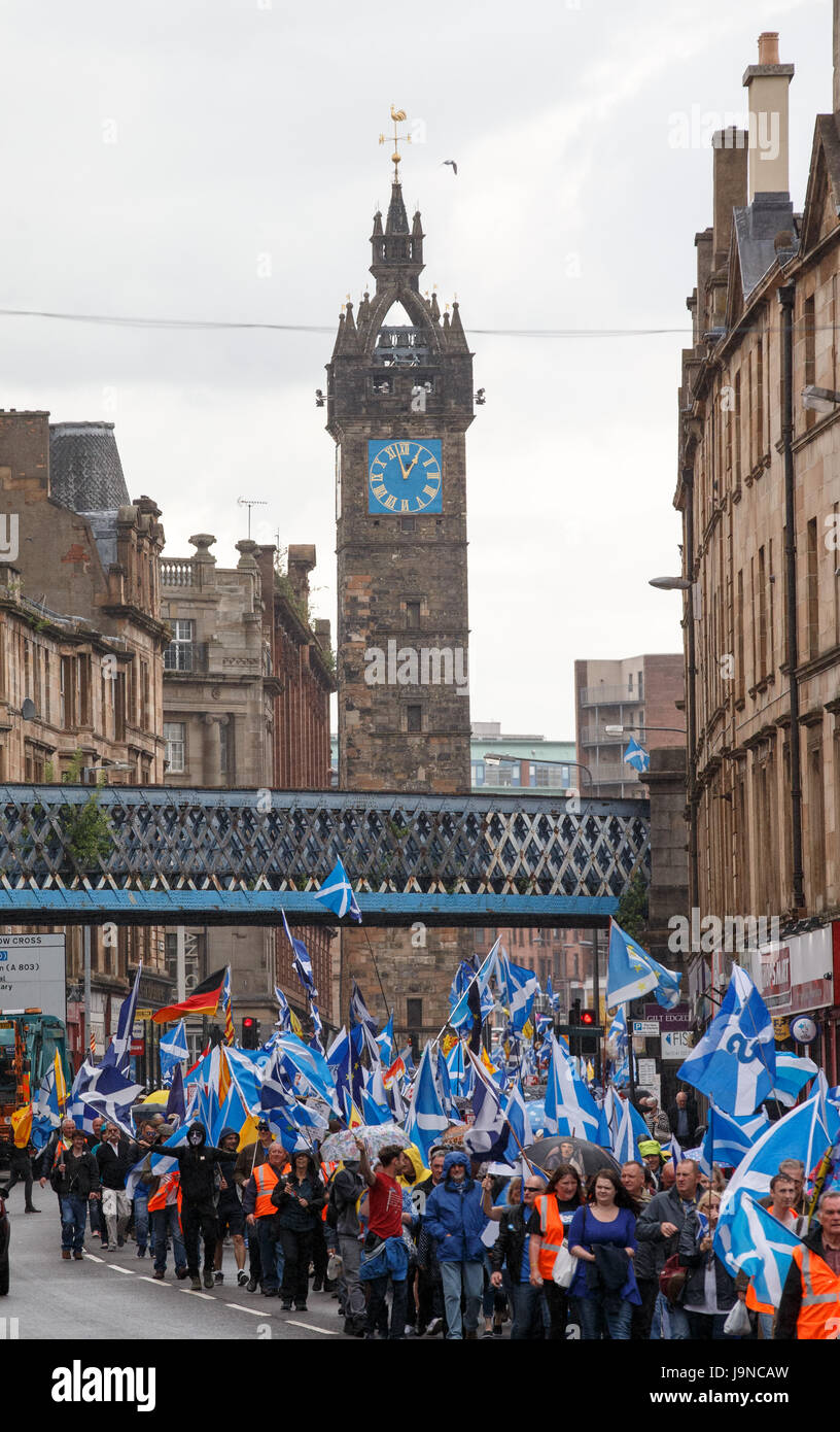 People taking part in the March for Independence through Glasgow wave ...