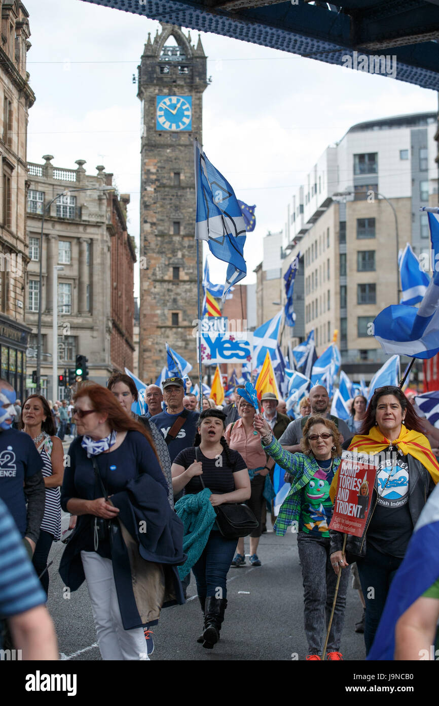 People taking part in the March for Independence through Glasgow wave ...