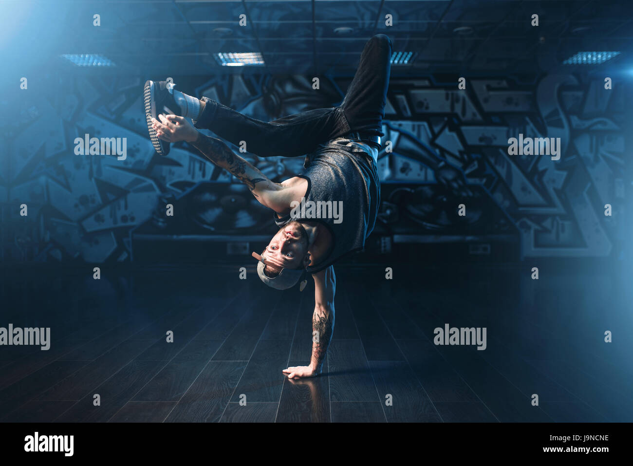 Breakdance action, dancer posing in dance studio. Modern urban dancing style Stock Photo - Alamy