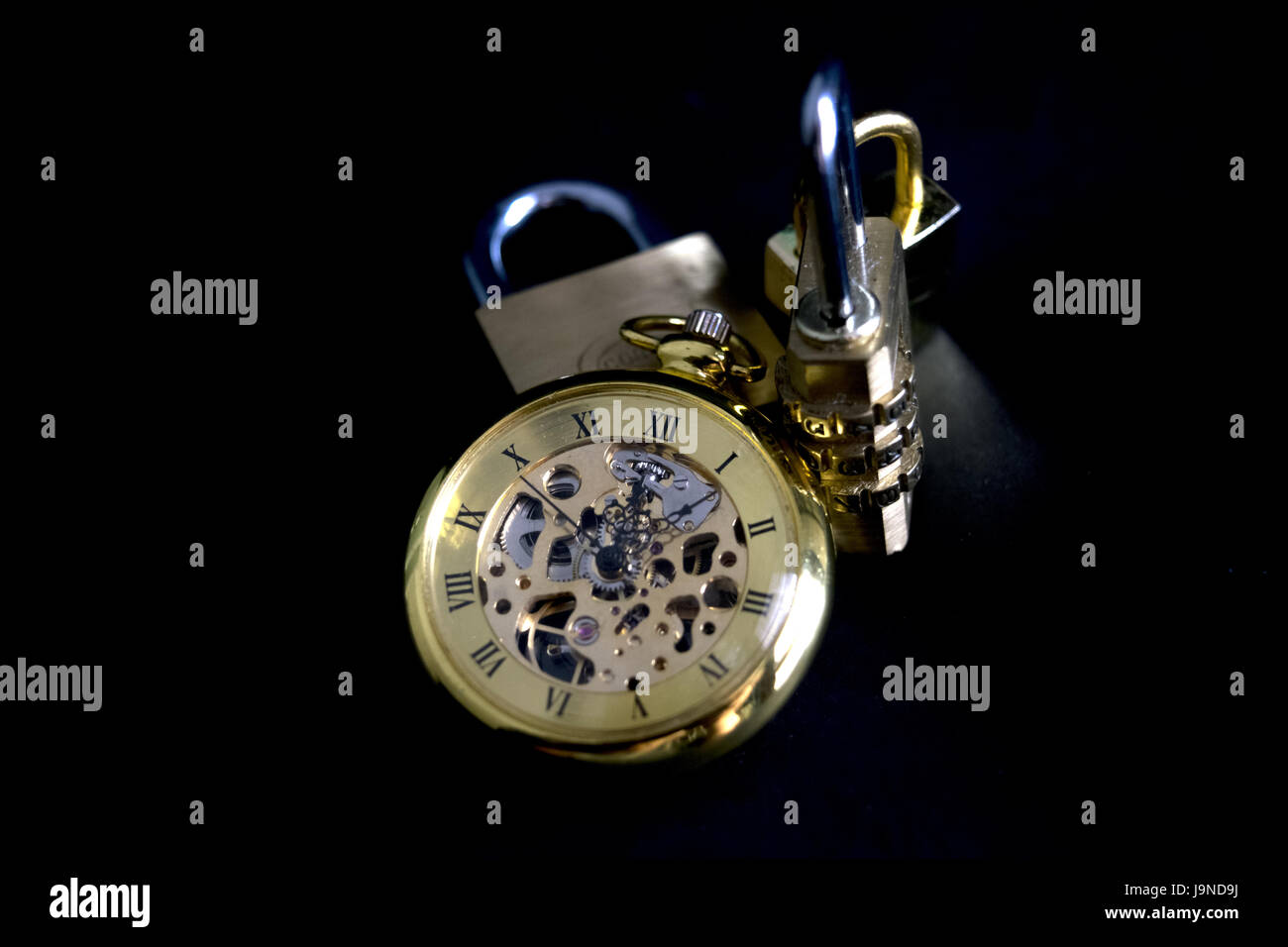time and security with an old clock and some padlocks Stock Photo - Alamy