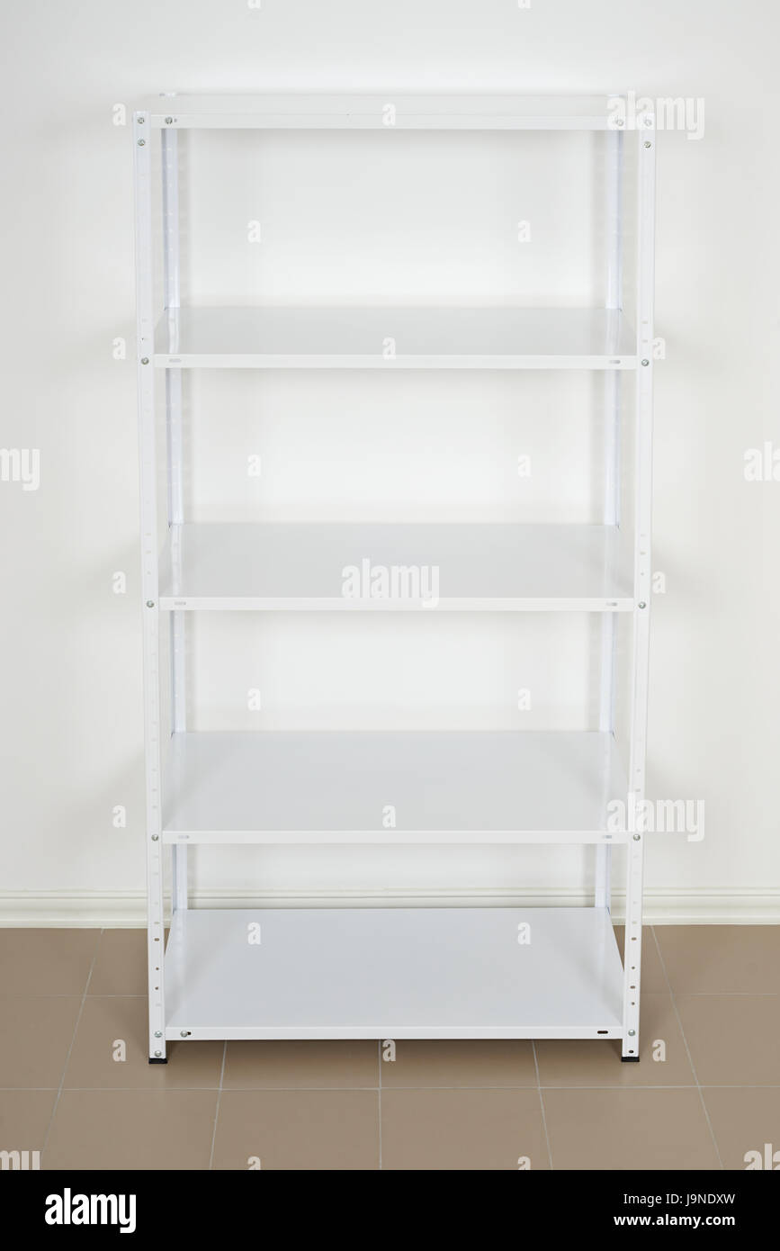 white metal rack near the wall, empty shelves Stock Photo - Alamy