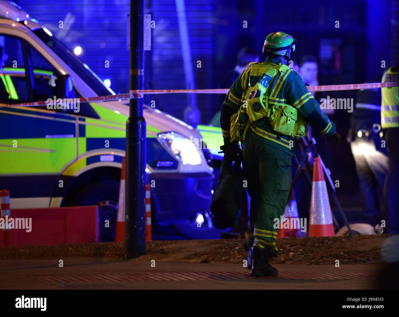 A paramedic rushes to the scene as police are dealing with a major ...