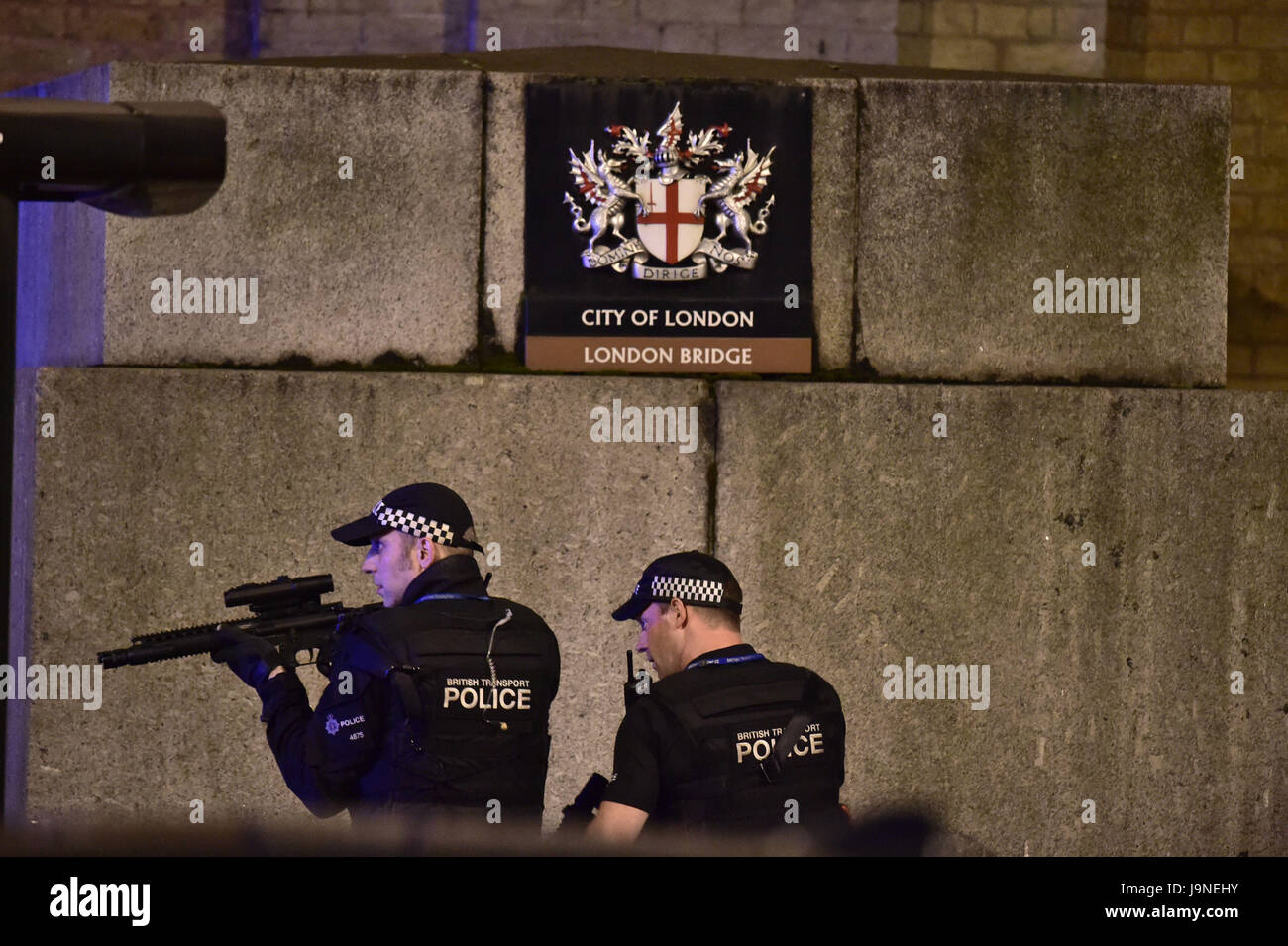Armed Police officer looks through his weapon on London Bridge as ...