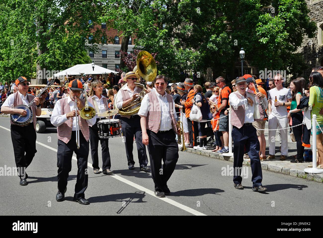 Princeton University alumni dressed in orange and black march joyously ...