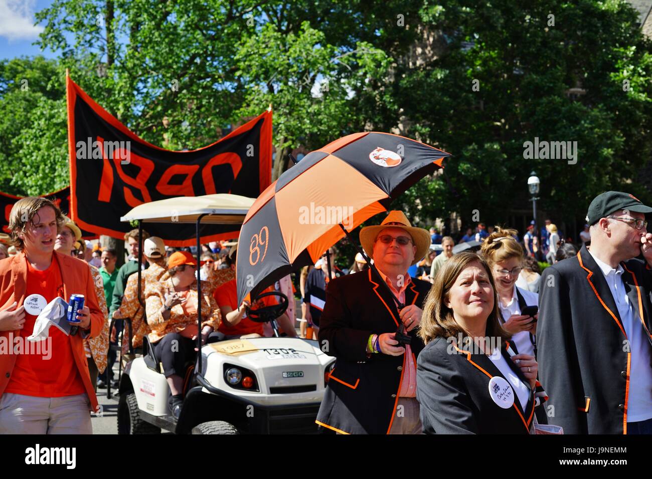 Princeton University alumni dressed in orange and black march joyously ...