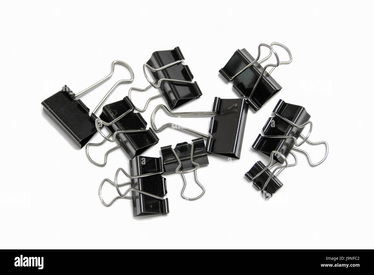 many black clips on white background Stock Photo - Alamy