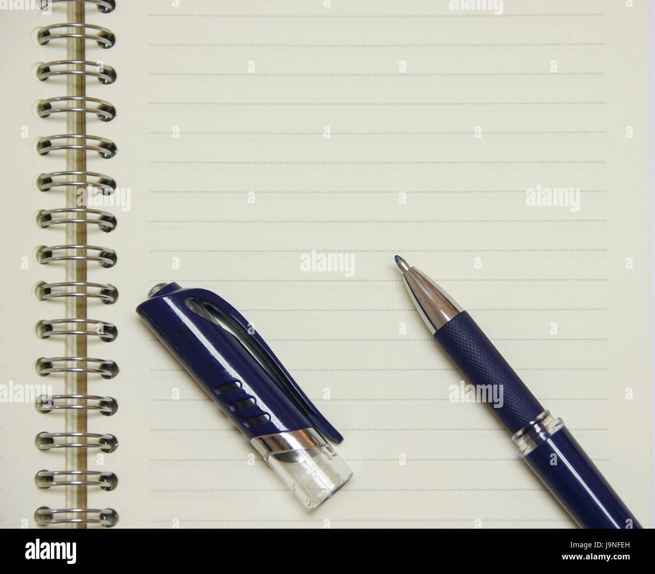 blue pen on notepad with spiral for memo, note, write, draw, text and ...