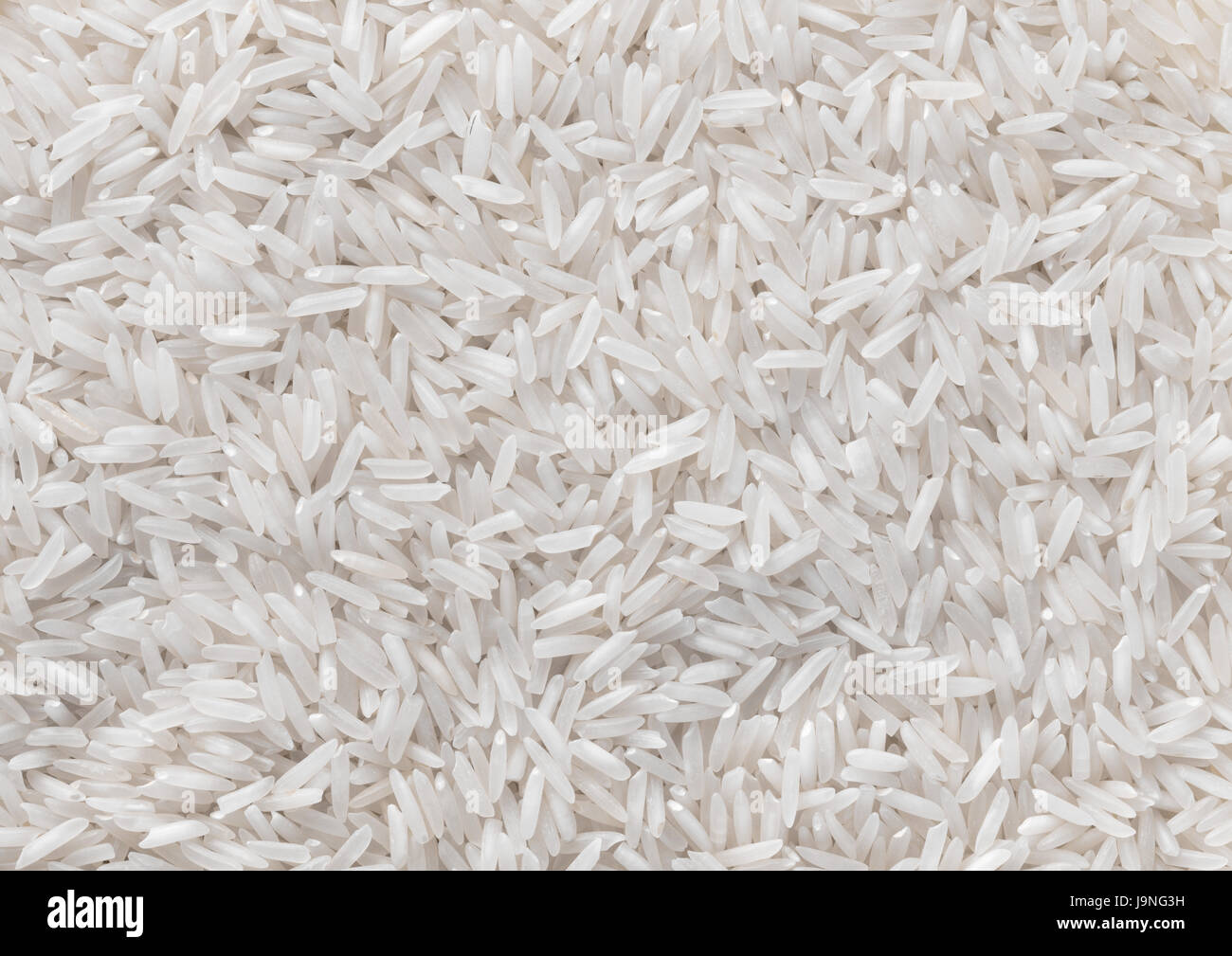 abstract background texture of uncooked rice closeup Stock Photo - Alamy