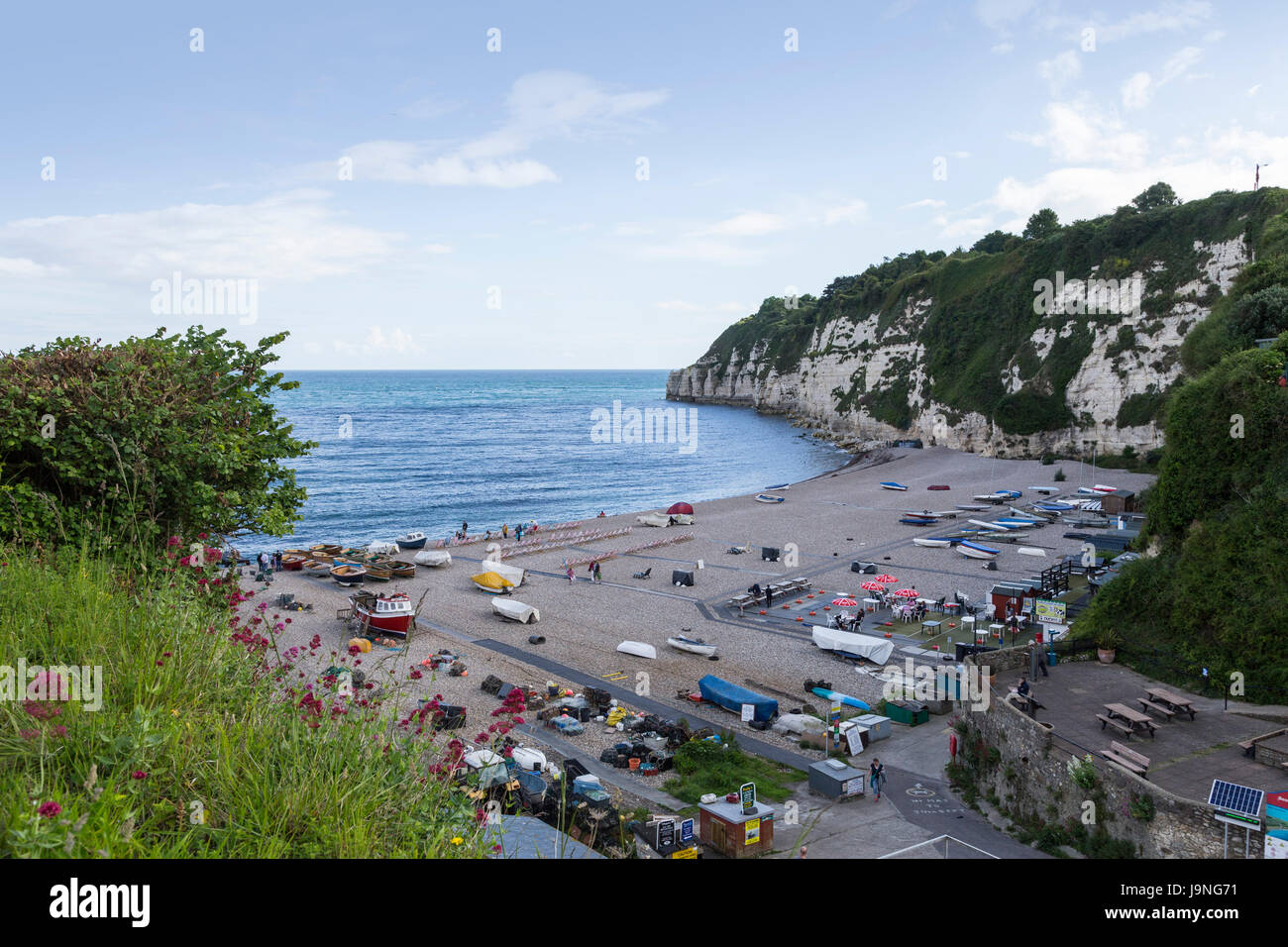 The beach, fishing boats, beach cafes and bay at Beer, Devon, a pretty ...