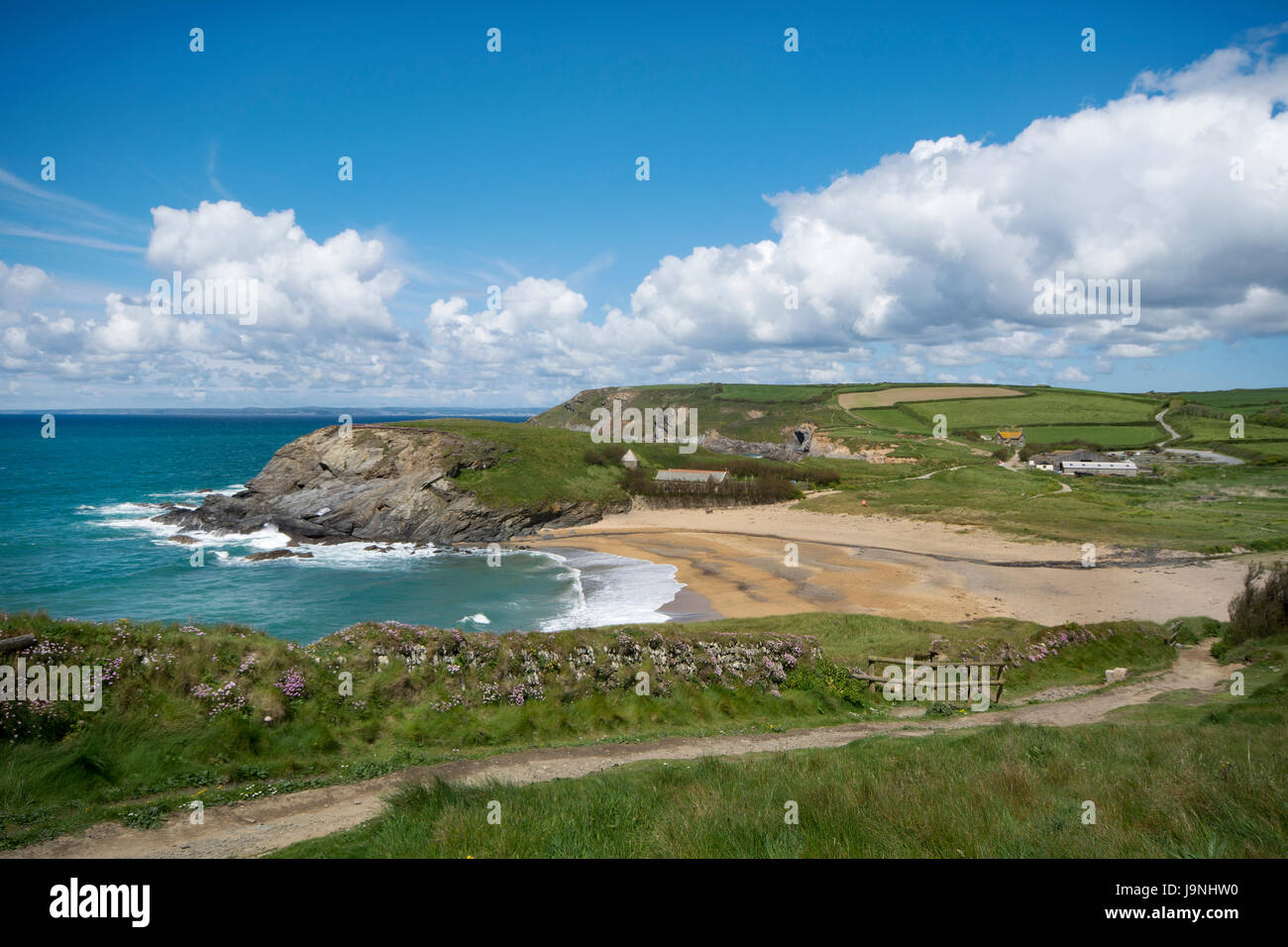 a view of church cove, Cornwall, a wide sandy beach inlet surrounded by ...
