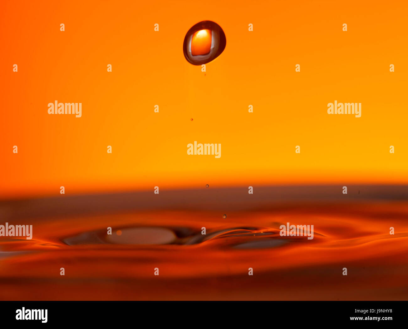drop of ink falling into liqiud, abstract background Stock Photo - Alamy