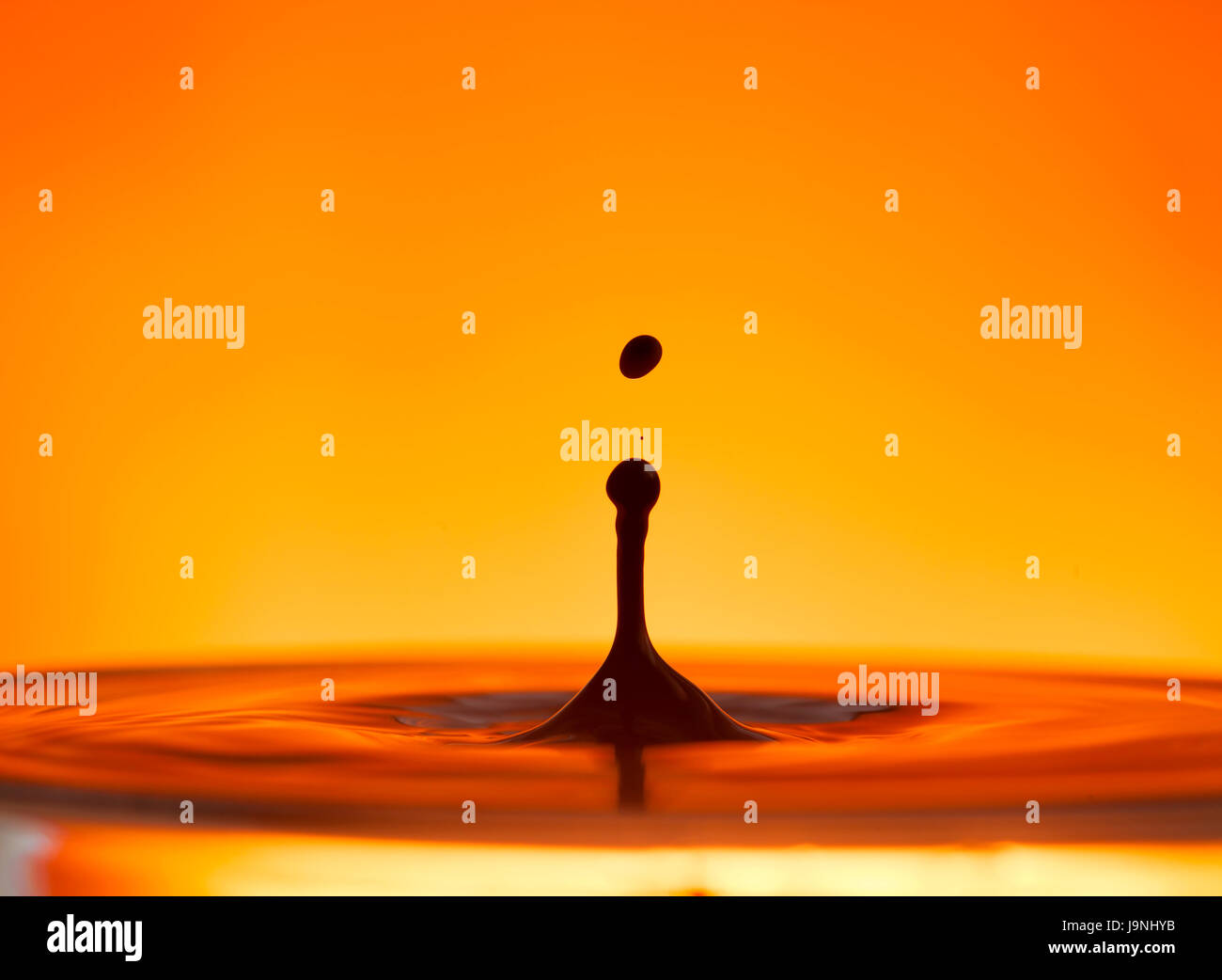 drop of ink falling into liqiud, abstract background Stock Photo - Alamy