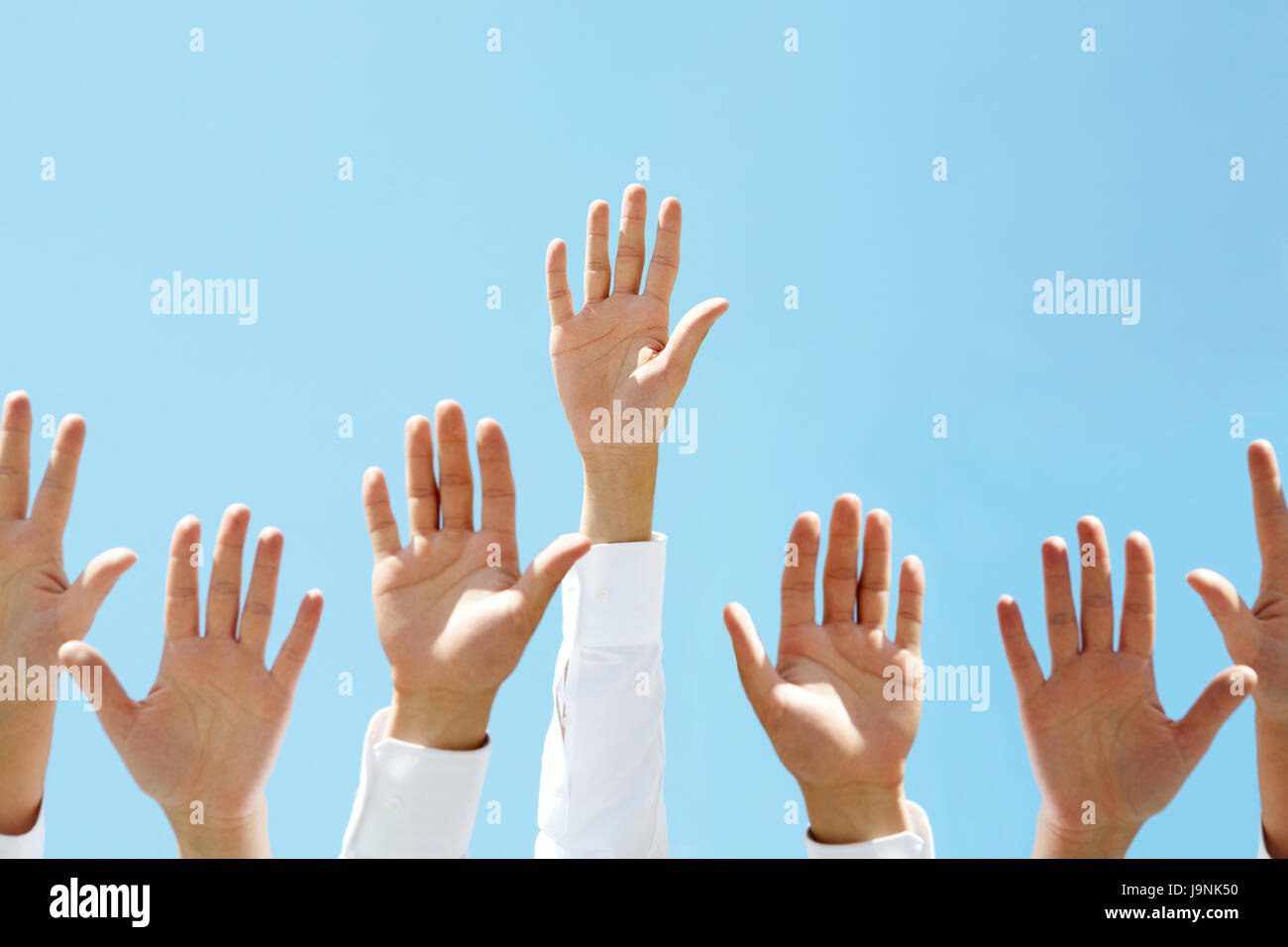 Several raising human hands hi-res stock photography and images - Alamy
