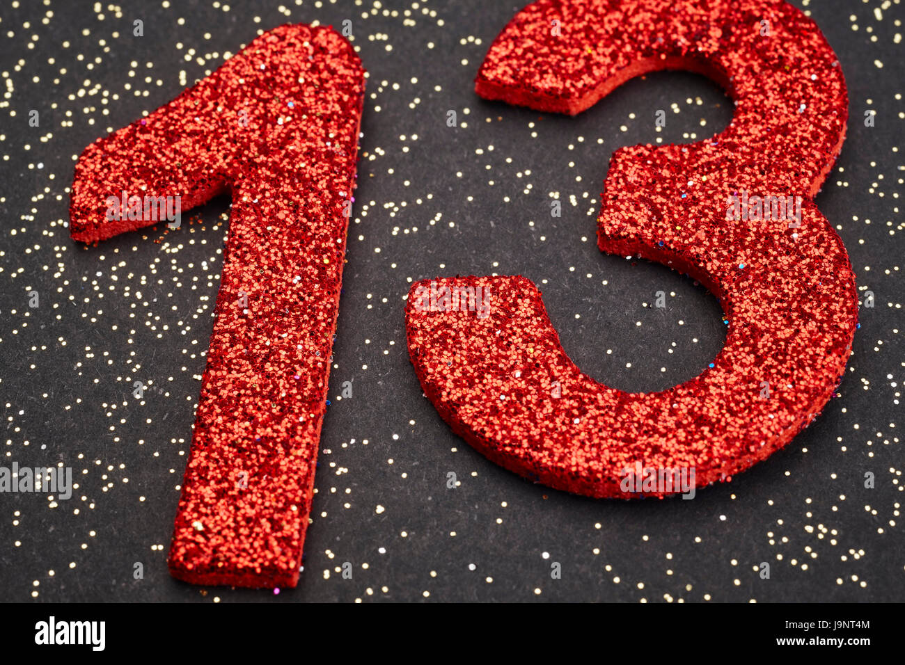 Number thirteen red color over a black background. Anniversary ...