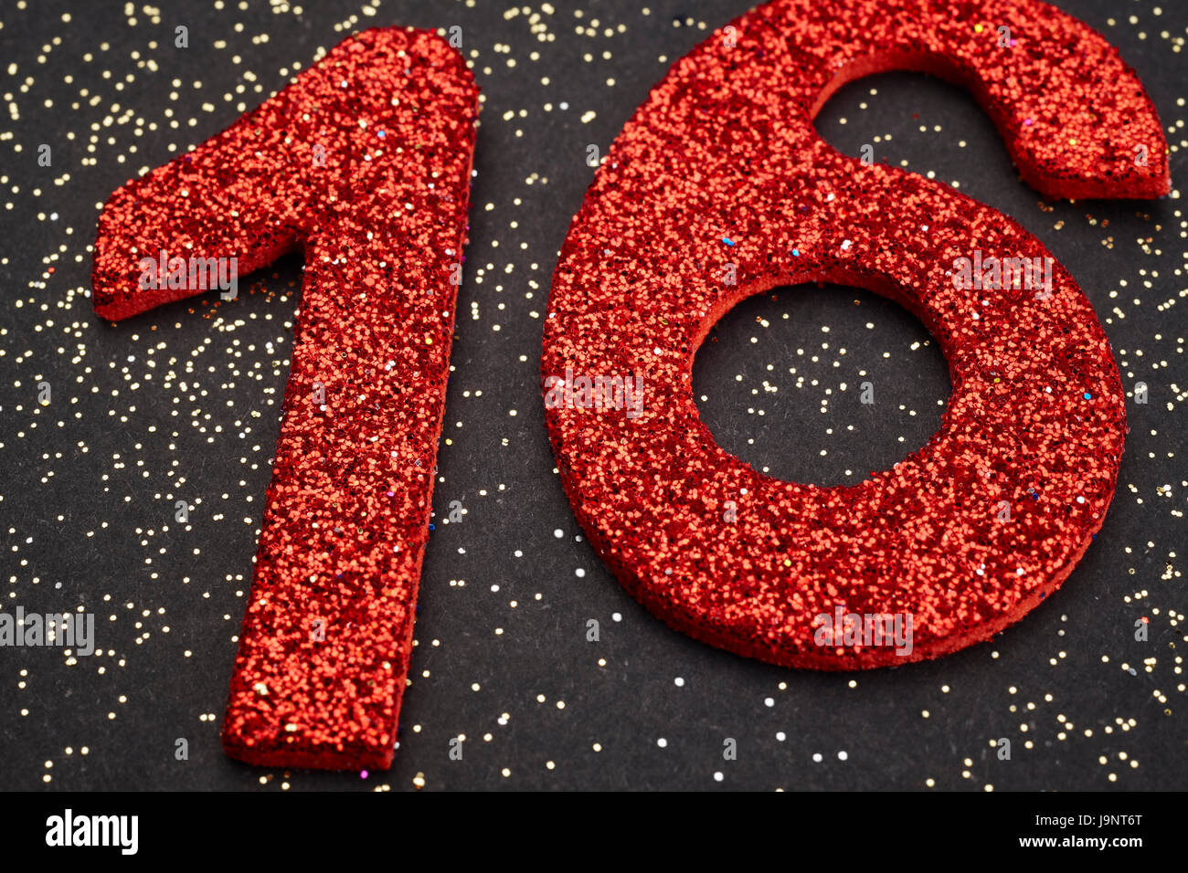 Number sixteen red color over a black background. Anniversary ...