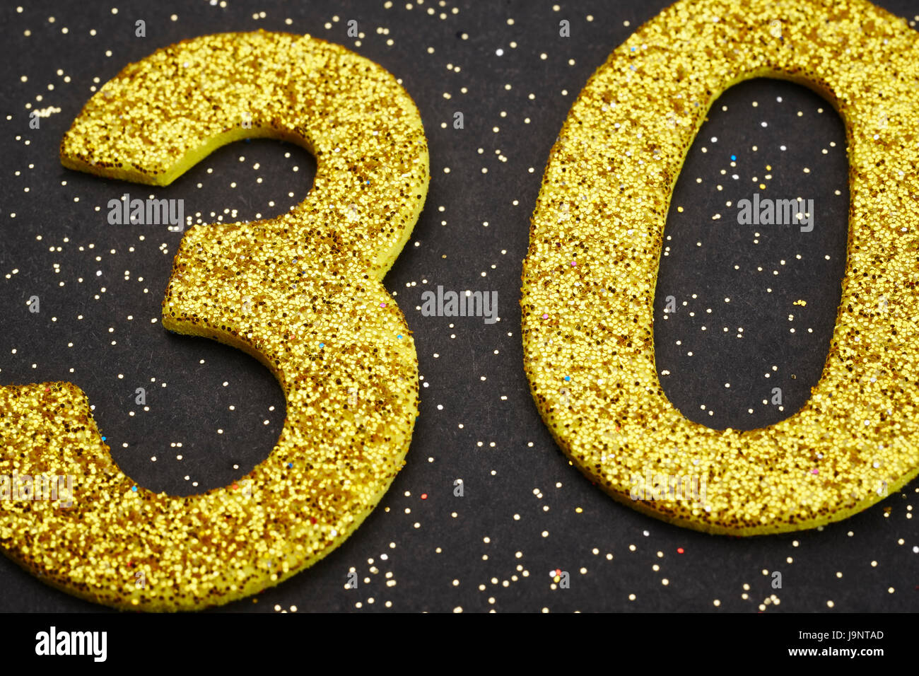 Number thirty yellow color over a black background. Anniversary ...
