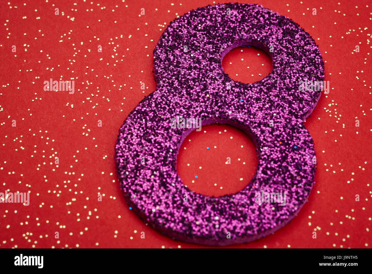Number eight purple color over a red background. Anniversary ...