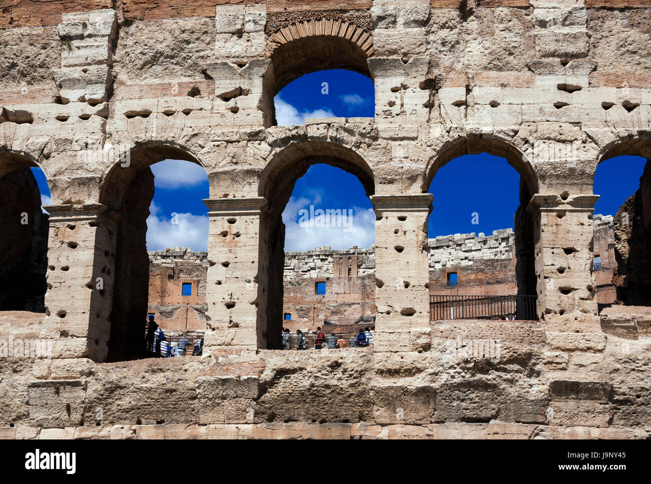 Coliseum monumental arcades with blue sky in Rome Stock Photo - Alamy
