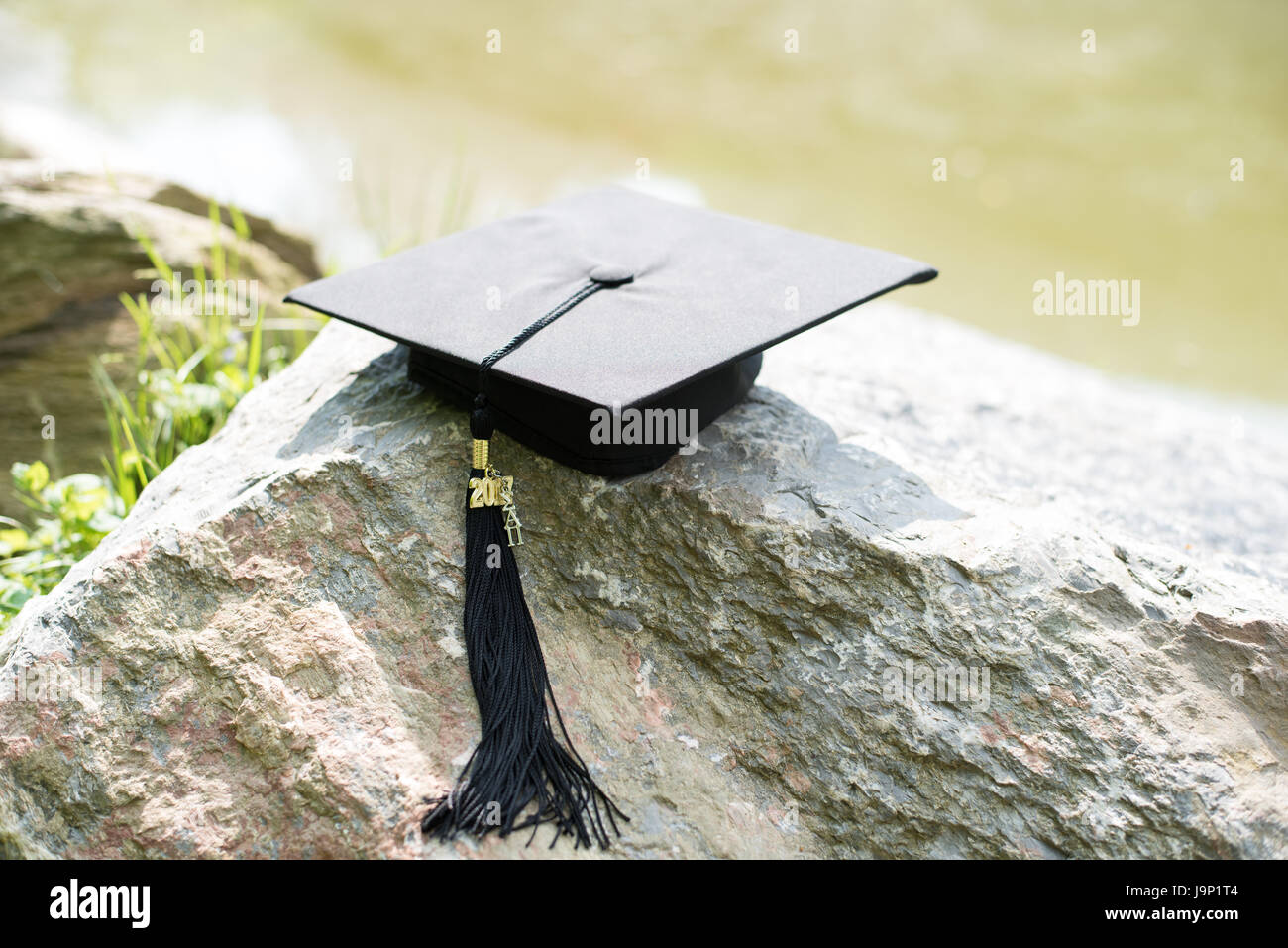 Graduation Cap on Rock Stock Photo - Alamy