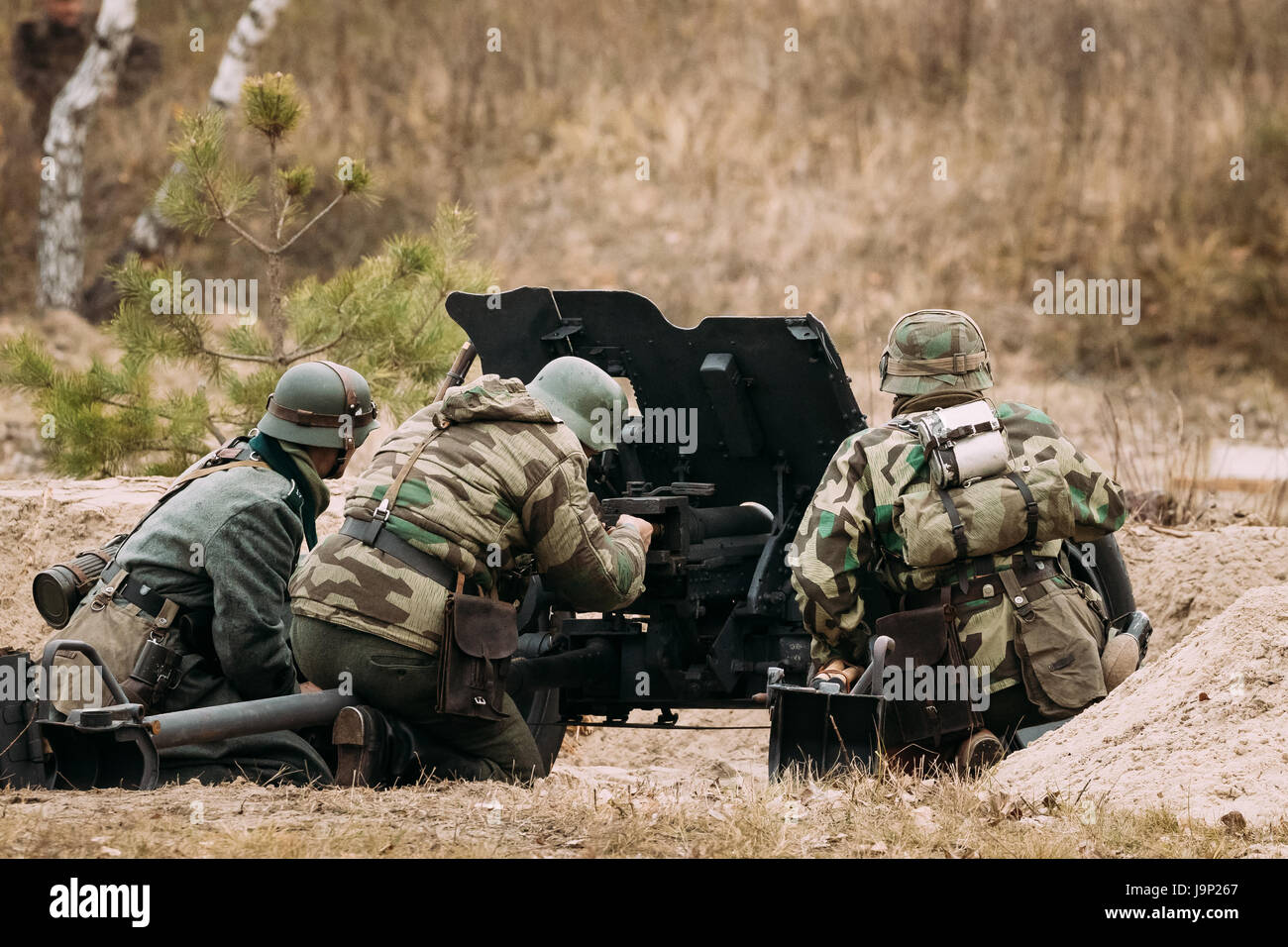 Re-enactors Dressed As German Soldiers In WWII Load A Cannon Shells At ...