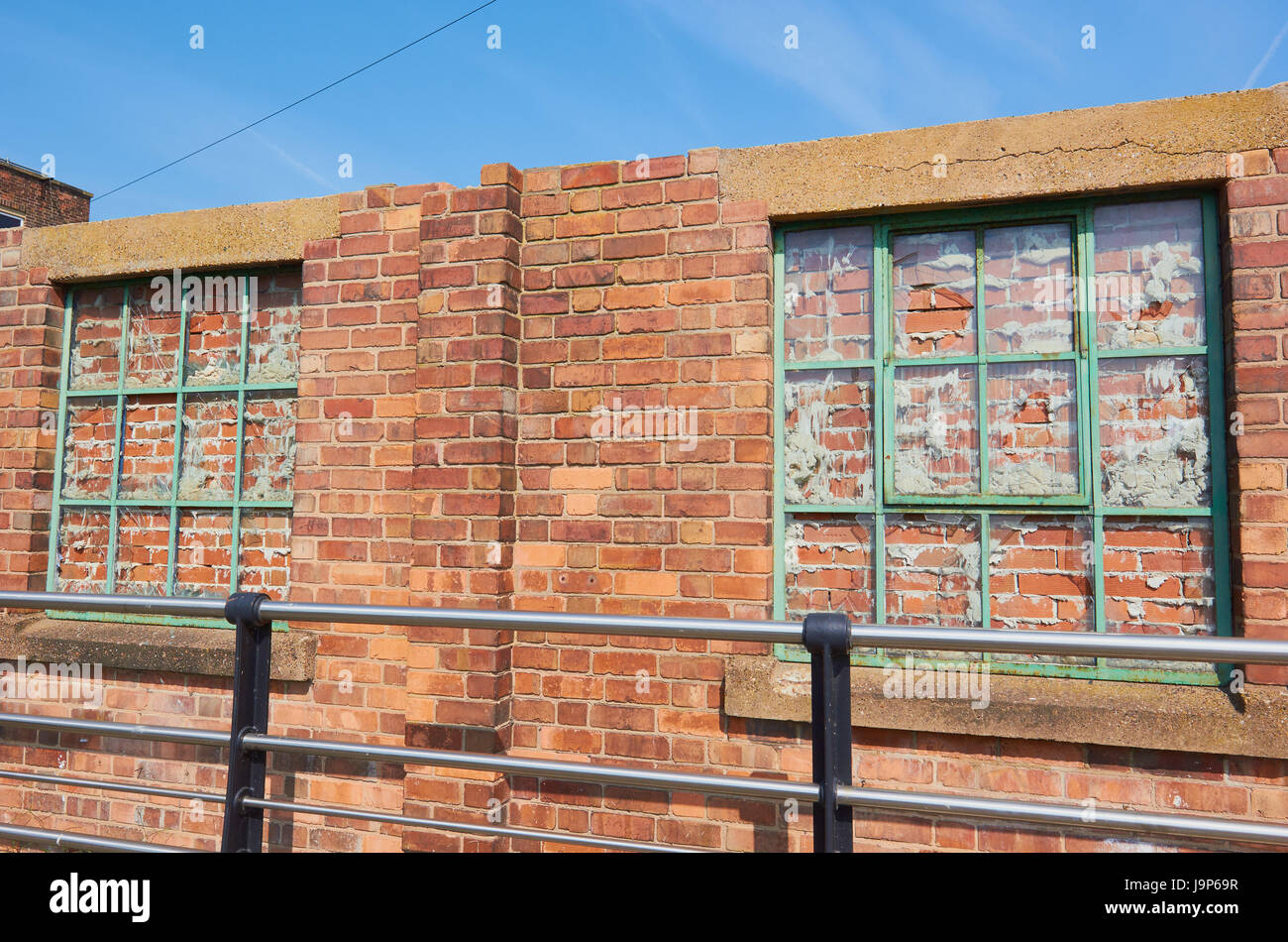 Bricked up broken windows Stock Photo - Alamy