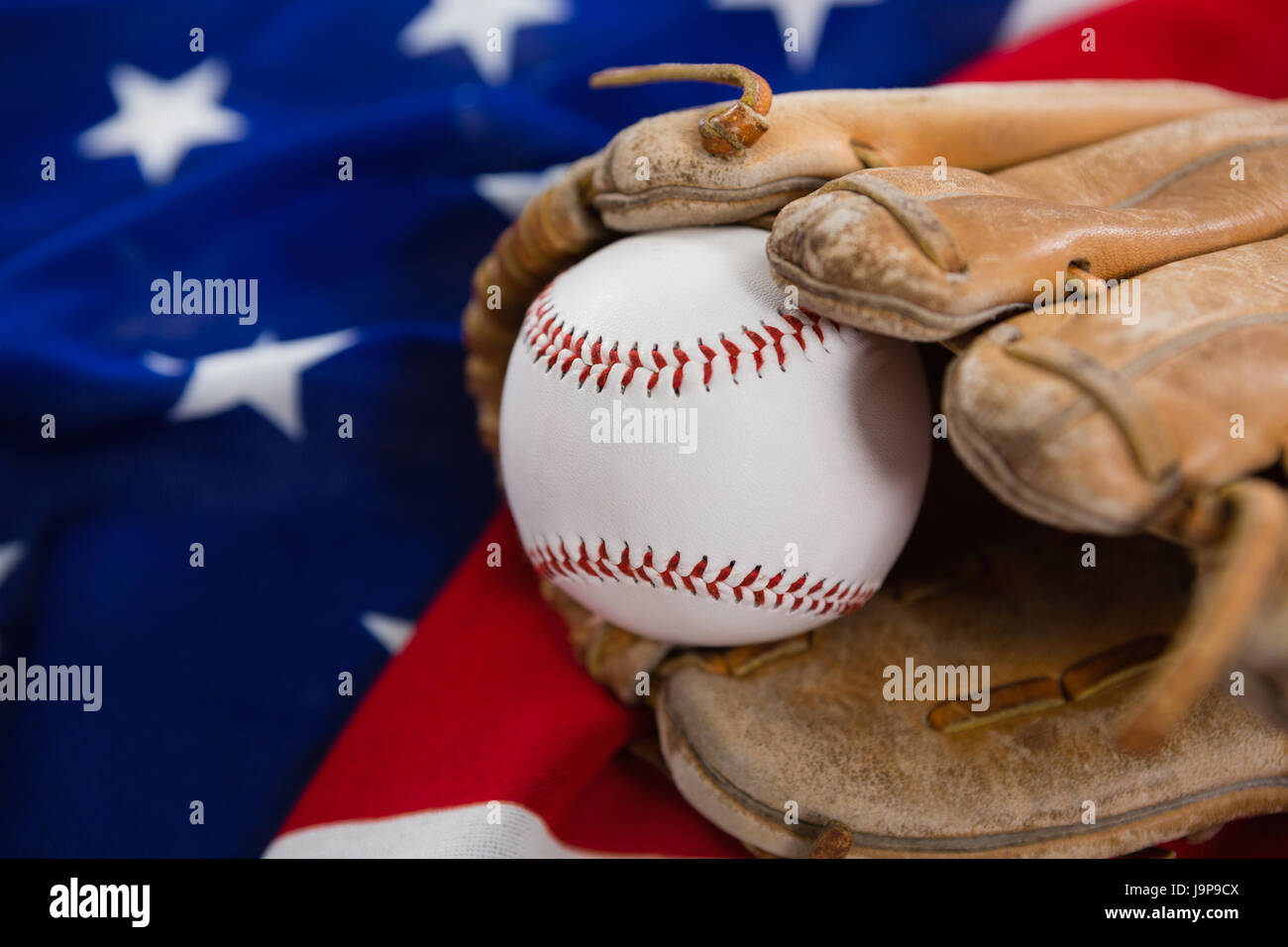 Close-up of baseball and gloves on an American flag Stock Photo - Alamy