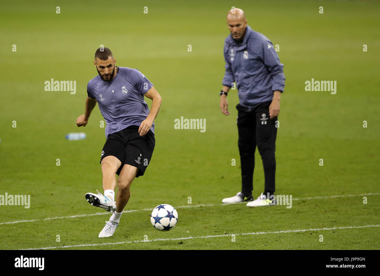 Real Madrid manager Zinedine Zidane (right) watches Karim Benzema ...