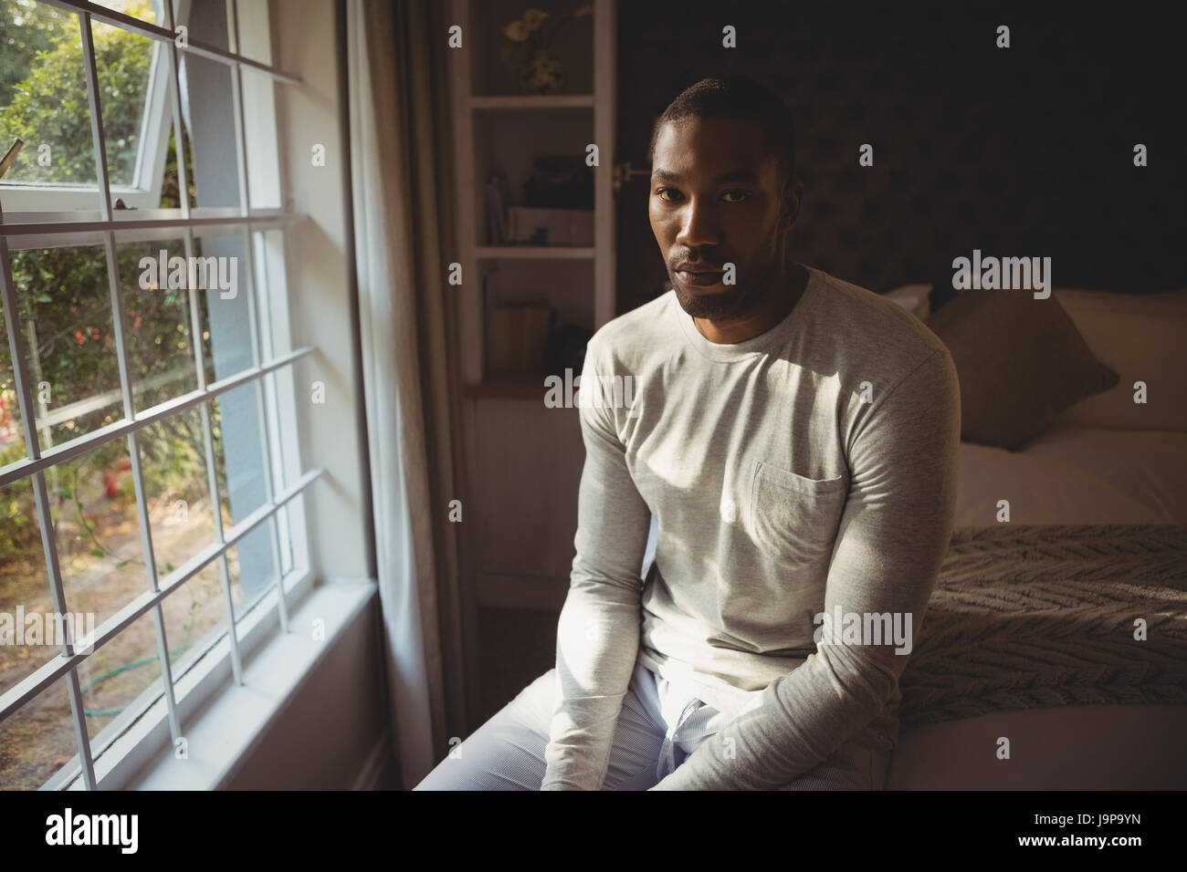 Man sitting window shadow hi-res stock photography and images - Alamy