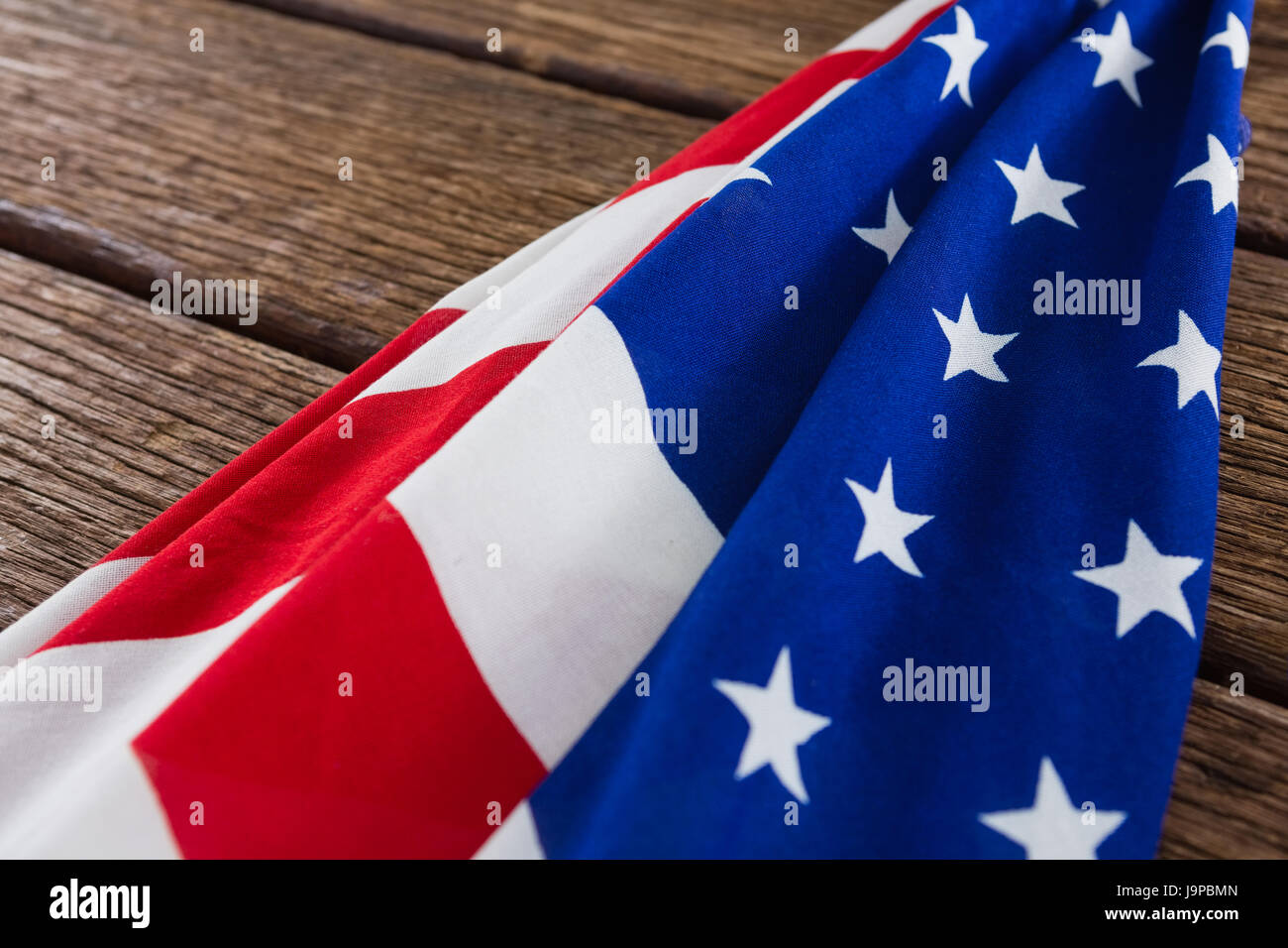 Close-up of an American flag on a wooden table Stock Photo - Alamy