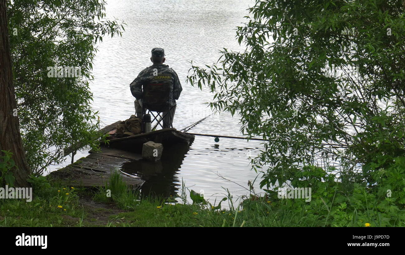 Kursk, Russia - May 28, 2017: a fisherman in the form of a guard sits ...