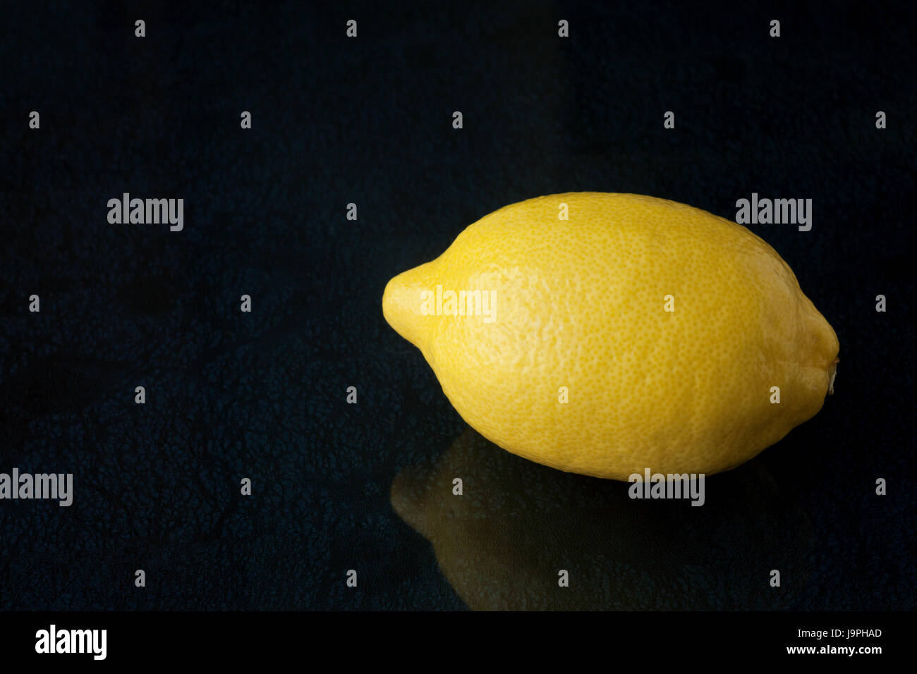 Lemon on a dark blue table Stock Photo - Alamy