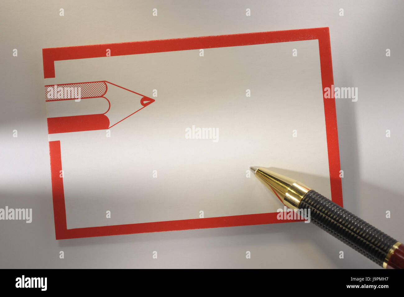 Note slip of paper with pen Stock Photo - Alamy