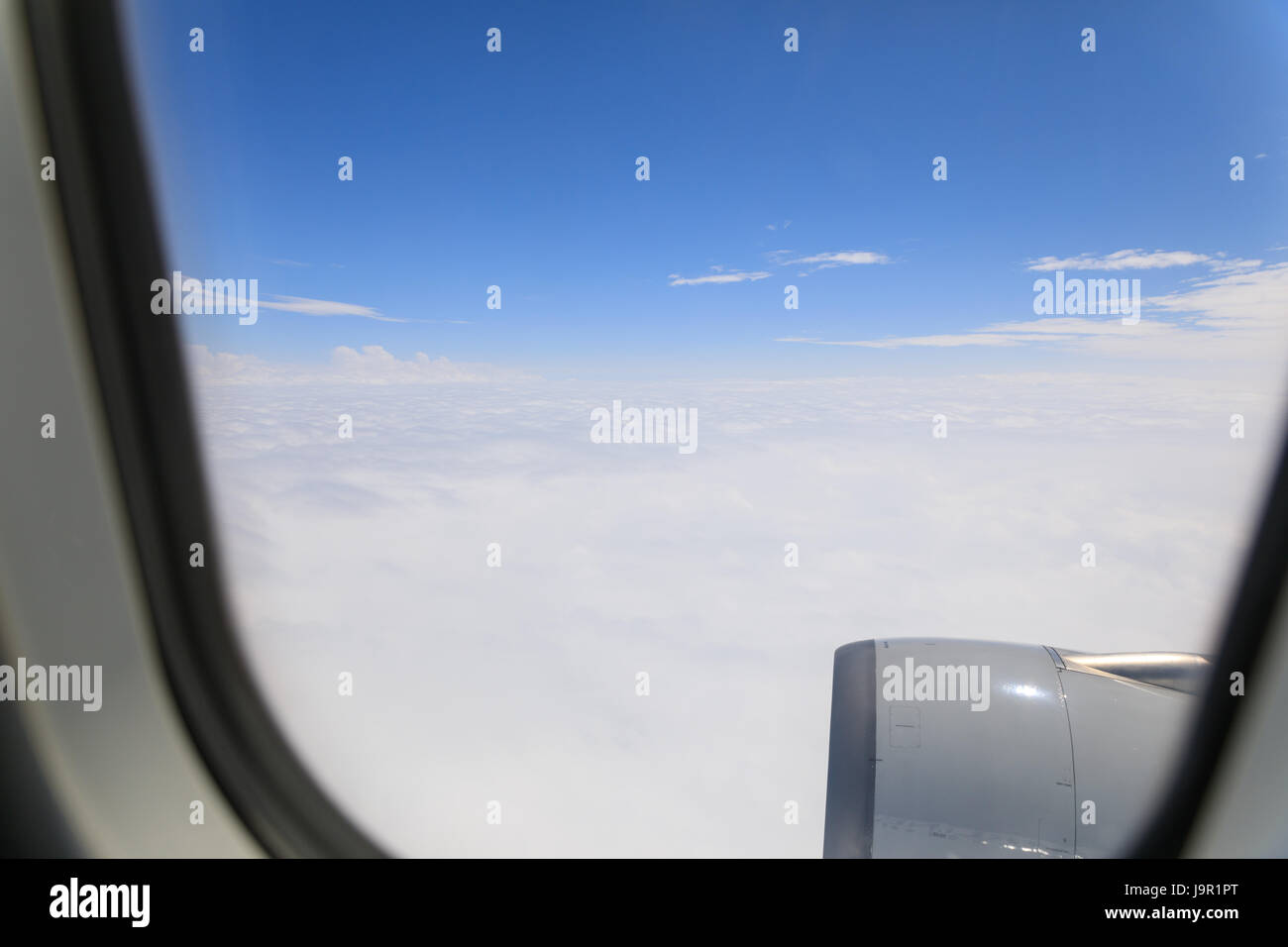 Looking through window aircraft during flight in wing with a blue sky ...