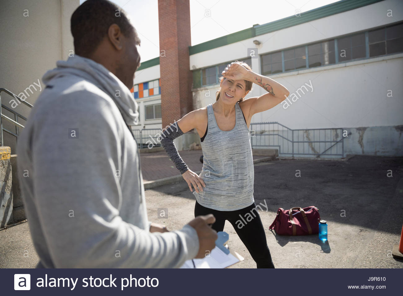 Woman and personal trainer talking hi-res stock photography and images ...