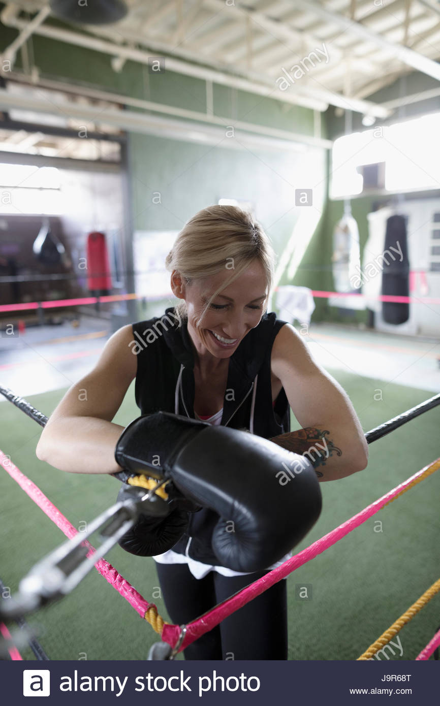 Smiling female boxer leaning on corner of boxing ring Stock Photo - Alamy