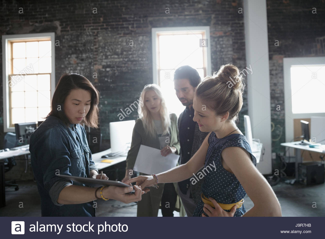 Creative business people with digital tablet meeting in office Stock ...