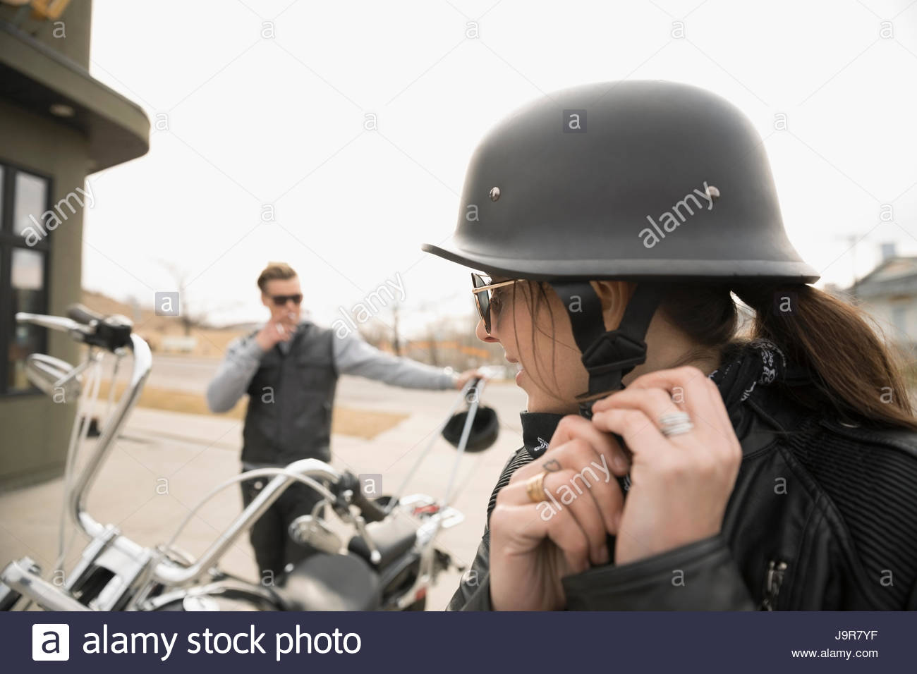 Woman on motorcycle taking off helmet hi-res stock photography and ...