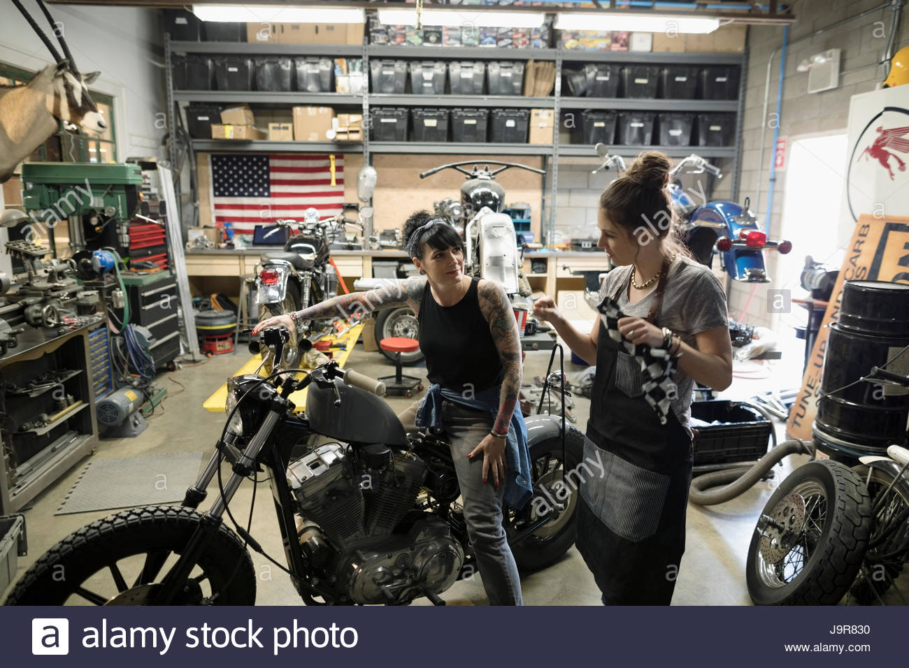 Female motorcycle mechanics fixing motorcycle hi-res stock photography ...