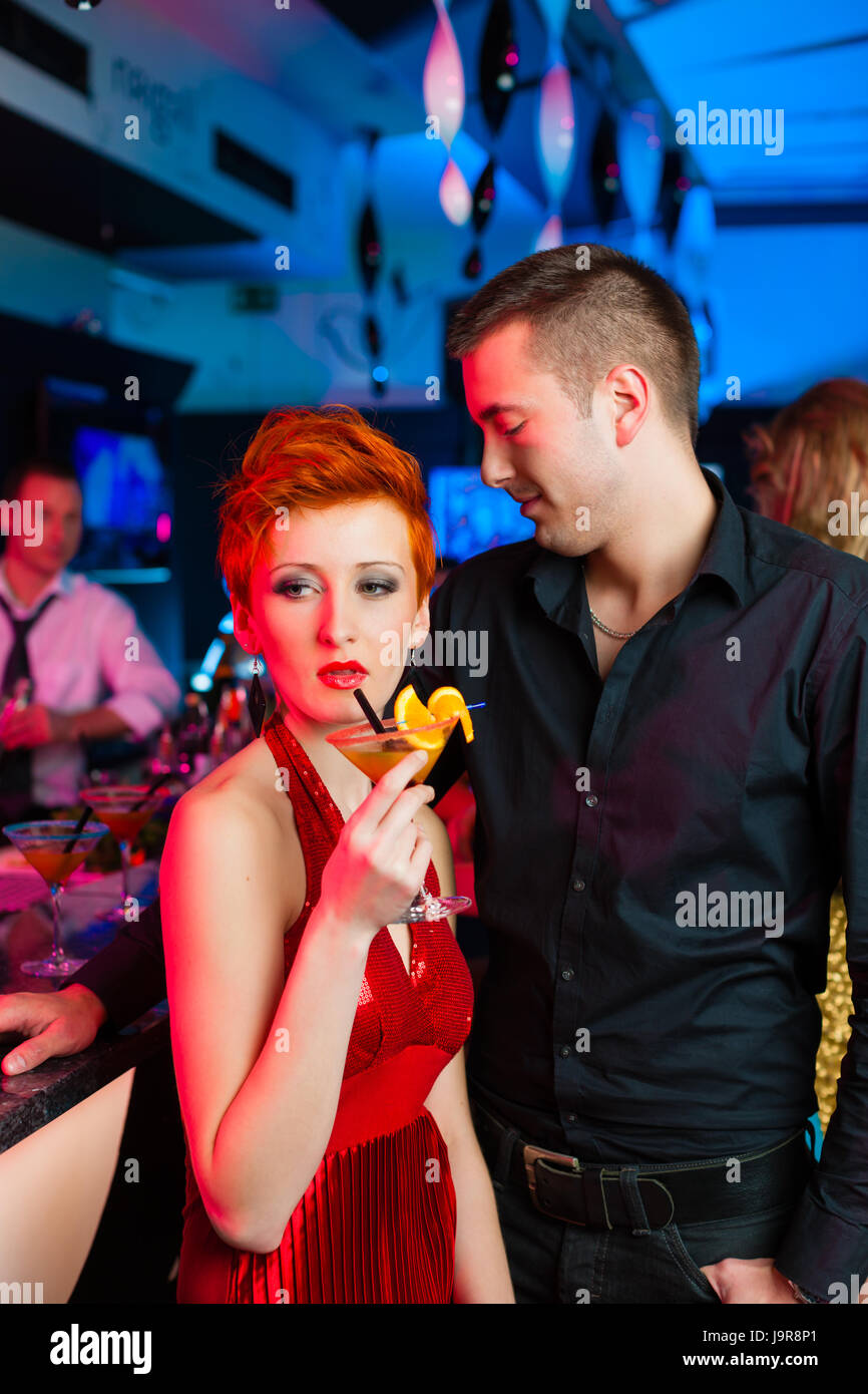young couple in a bar or club drinking cocktails Stock Photo - Alamy