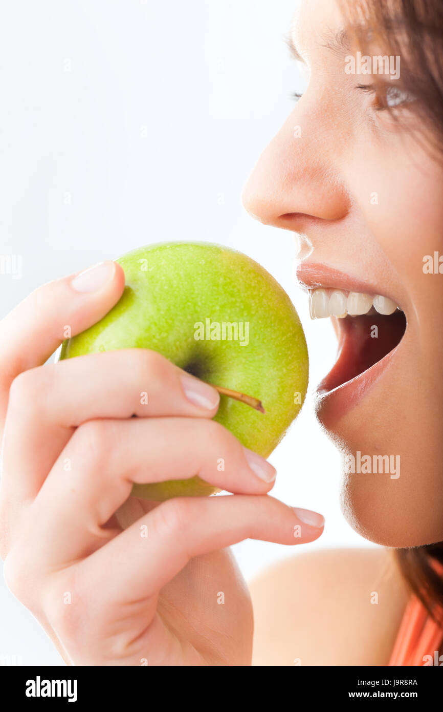 young woman biting into an apple Stock Photo - Alamy